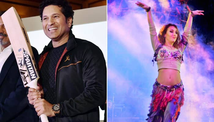Sachin Tendulkar poses with bat; An Ukrainian artist performs during ...