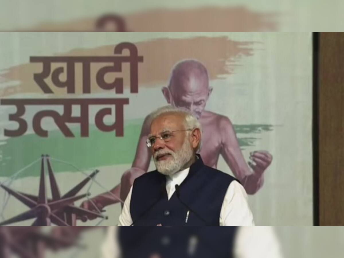PM Narendra Modi spins charkha at Khadi Utsav
