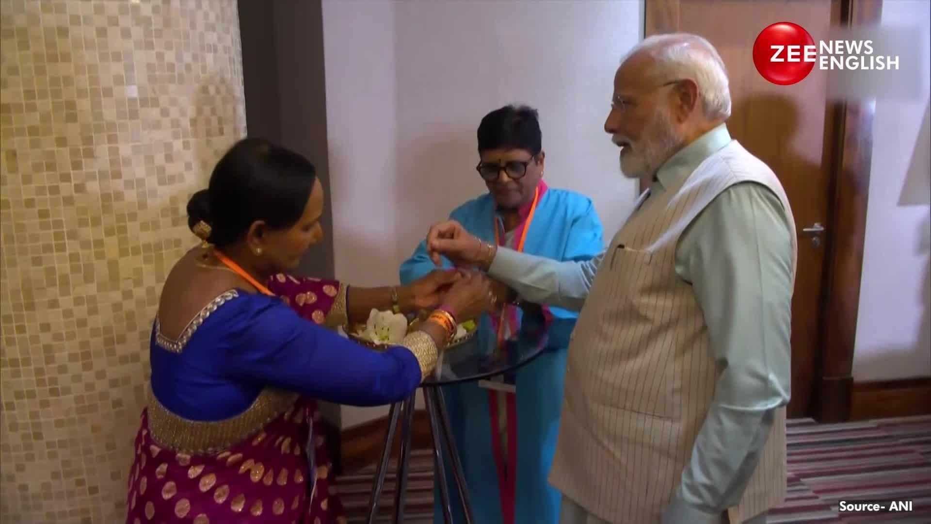 Indian community woman ties ‘Rakhi’ to Prime Minister Narendra Modi ...