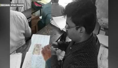 Students stuck currency notes to bribe qualifying exam | Zee News