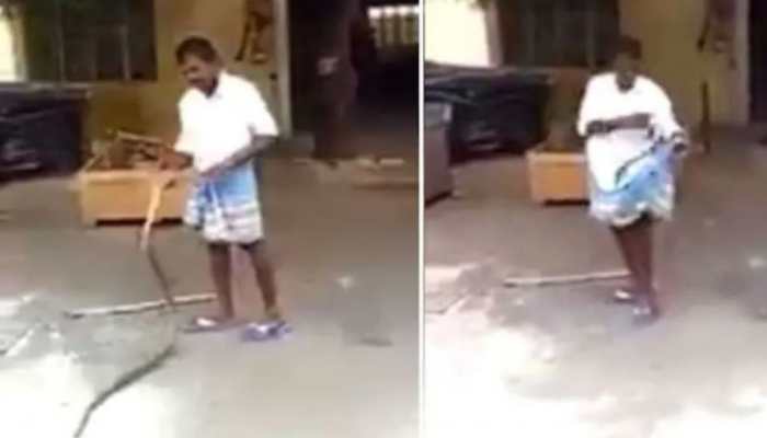 Shocking video! Brave man catches snake, puts it in his lungi fold and ...